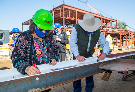Hancock Marks Progress on Fine Arts Complex With Beam Signing Ceremony